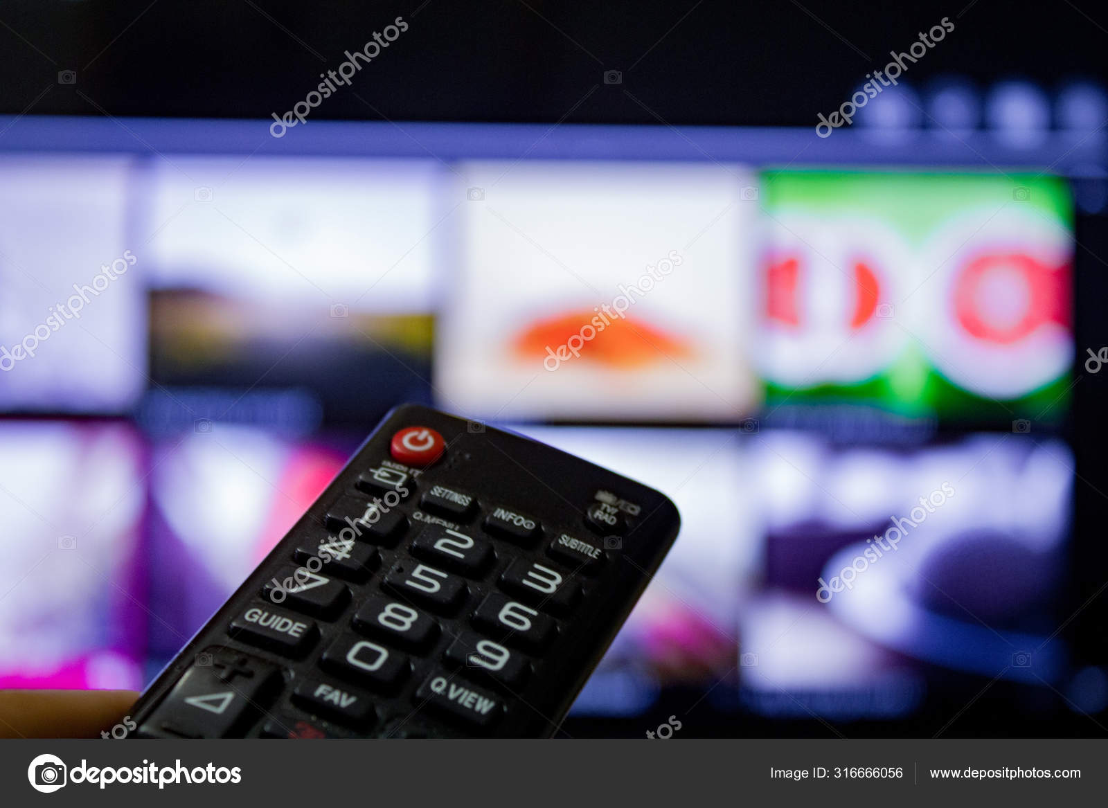Watching TV and using remote controller — Stock Photo © allmy #316666056