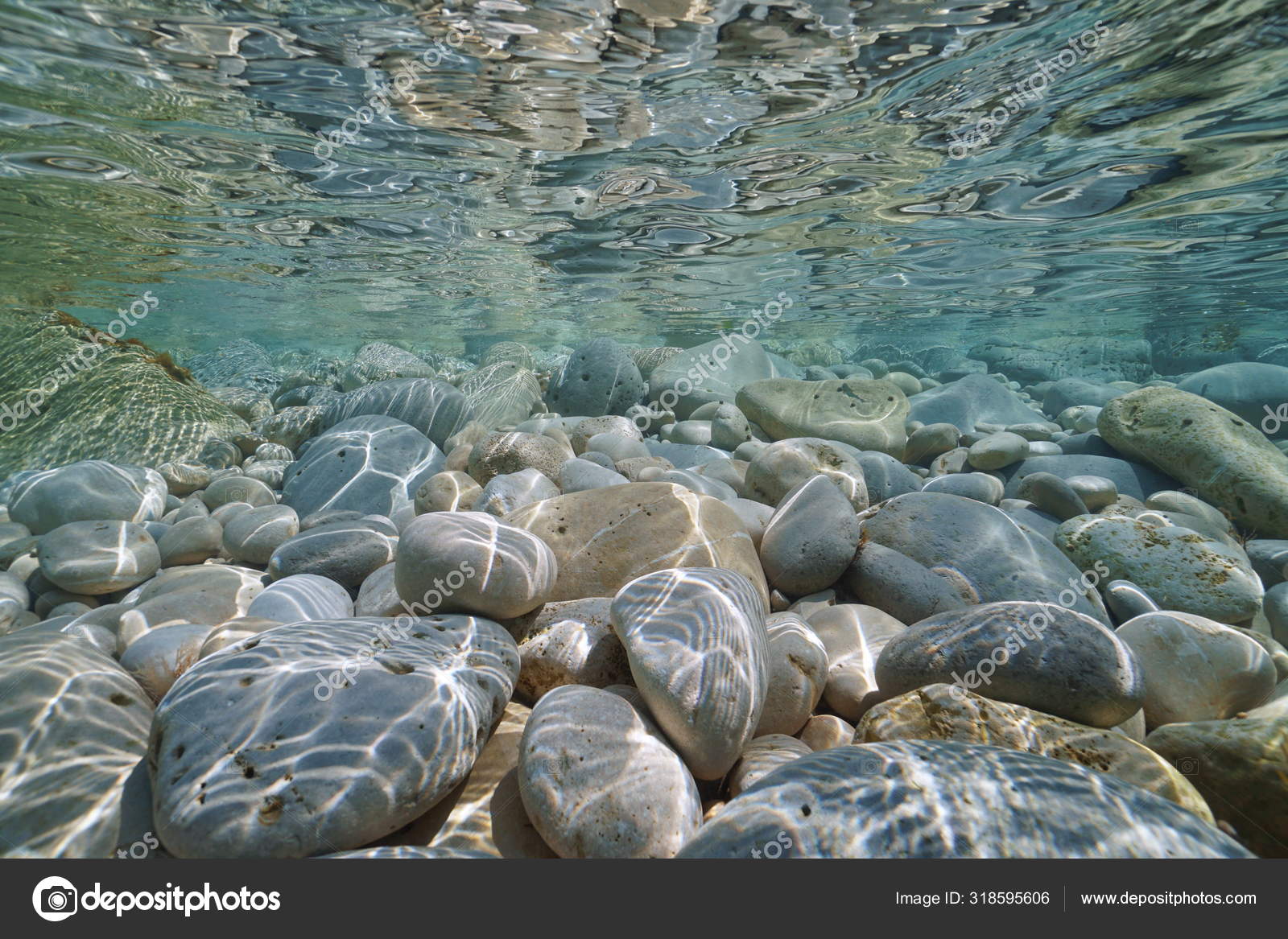 Pebbles and rocks below water surface Stock Photo by ©wildam 318595606