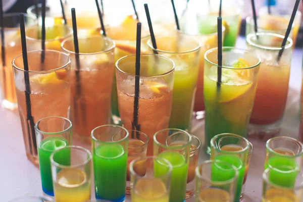 Beautiful line of different colored cocktails with smoke on a Christmas ...