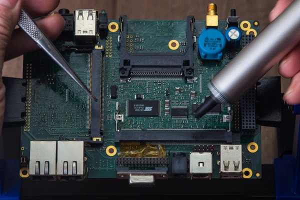 Fix and repair of electronic computer board - Stock Image - Everypixel