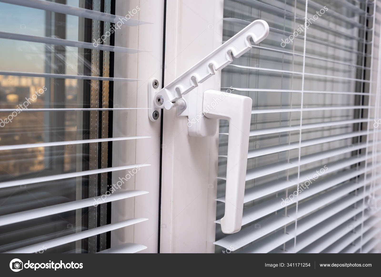 A handle and a restrictor, window stopper or limiter on PVC double ...