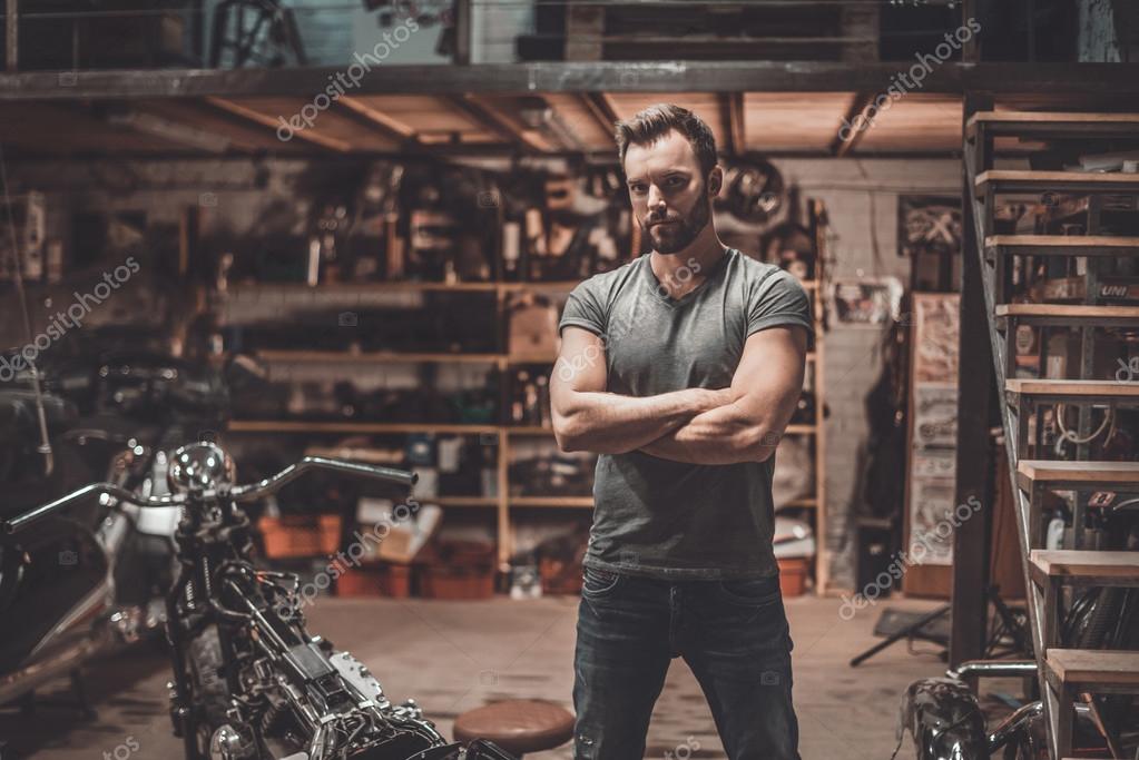 Handsome man with motorcycle — Stock Photo © gstockstudio #126770984