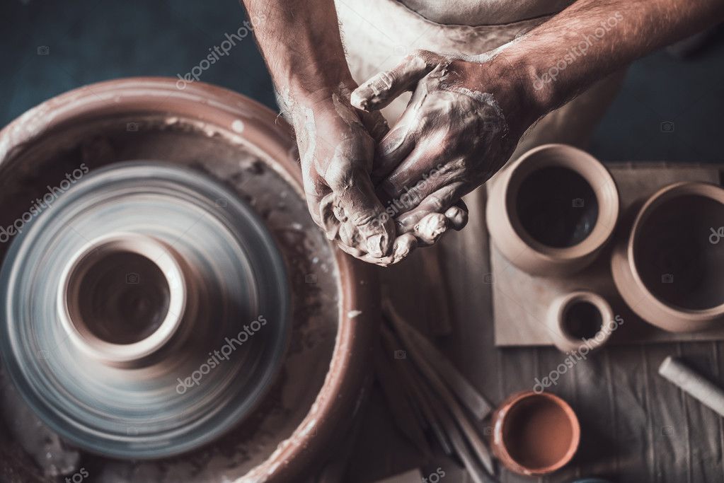 Potter standing near pottery wheel — Stock Photo © gstockstudio #128789846