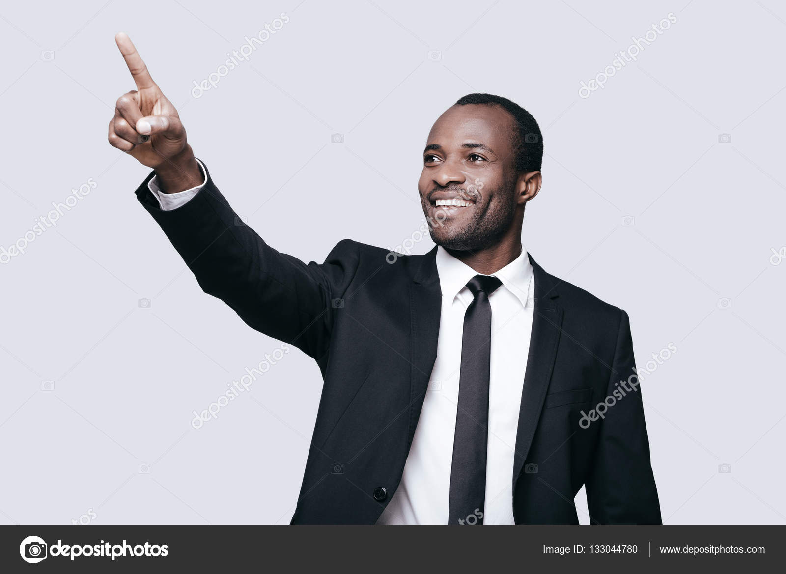 Man pointing away and smiling Stock Photo by ©gstockstudio 133044780
