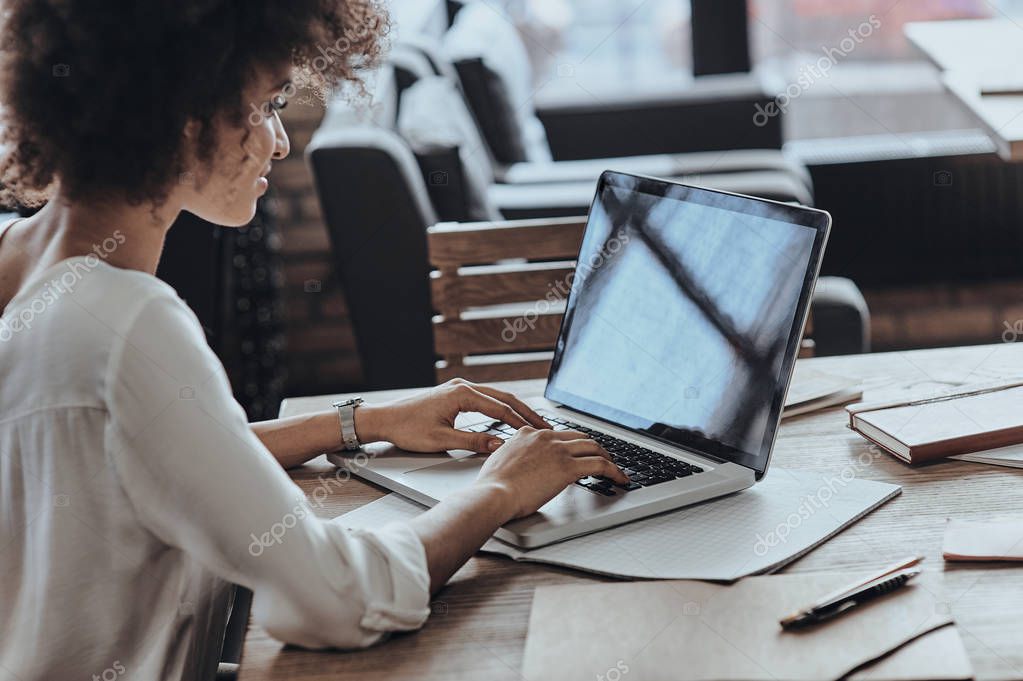 African woman using laptop — Stock Photo © gstockstudio #149139673