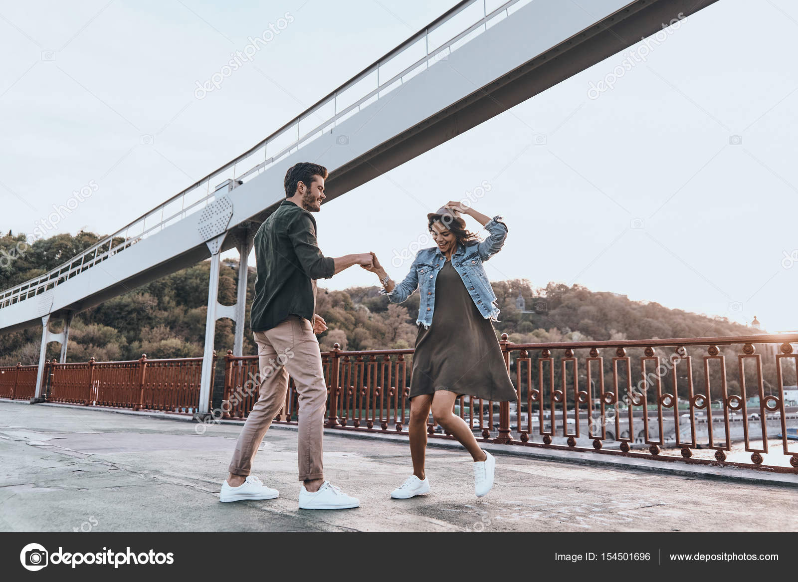 Casual couple dancing on bridge — Stock Photo © gstockstudio #154501696