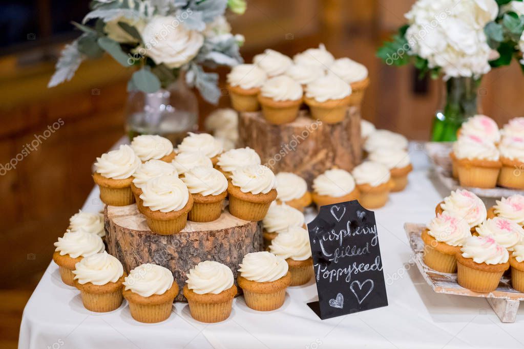 Wedding Cupcakes on Dessert Table — Stock Photo © joshuarainey #187049946