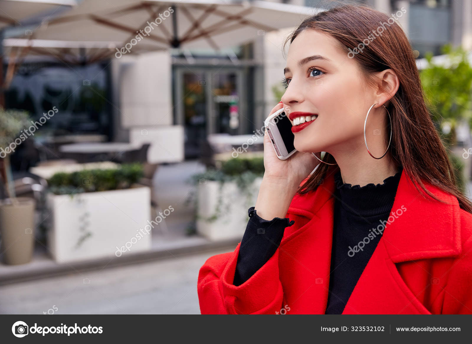 Shy cute unsurpassed lady talking on gray mobile phone and smiling ...
