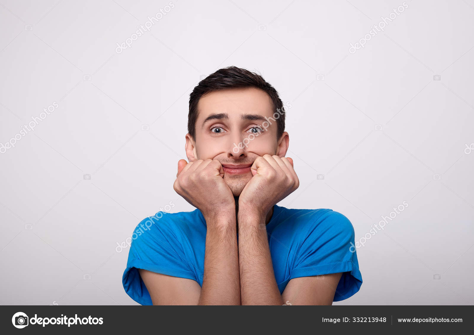 A scared young guy in a blue T-shirt. Stock Photo by ©AVOCADO_FAM 332213948