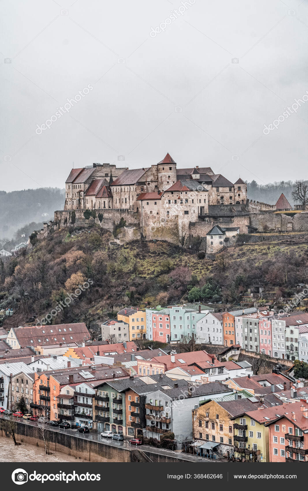 Burg zu Burghausen, castle complex on hill along river during rainy ...