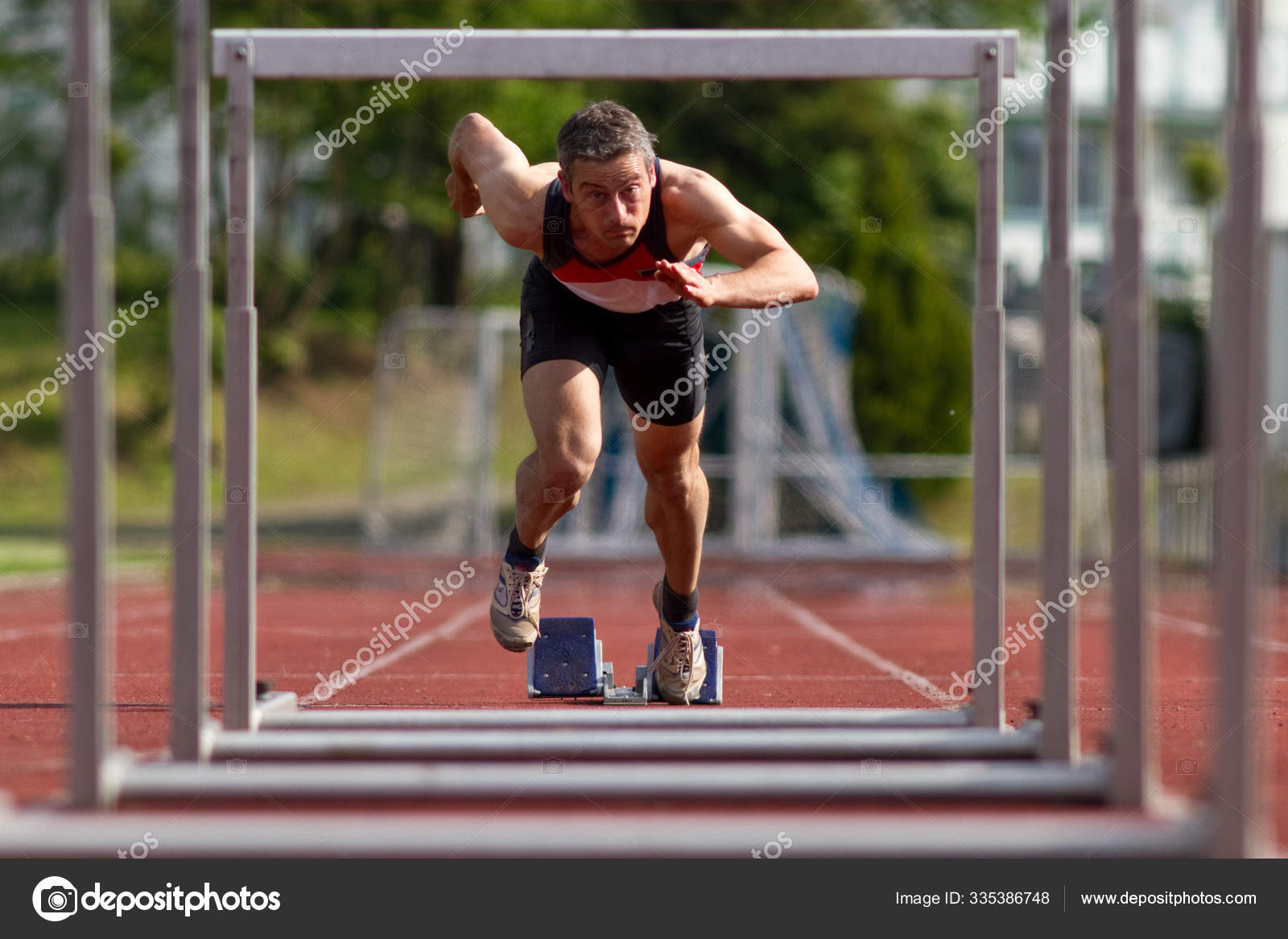 Athletic Man Running Track — Stock Photo © PantherMediaSeller #335386748