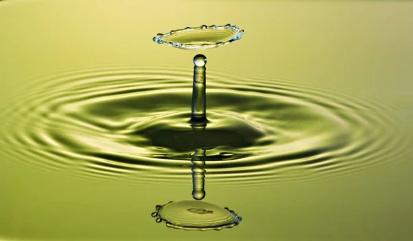 Gravity - Dancing waterdrop on a green background - Stock Image ...