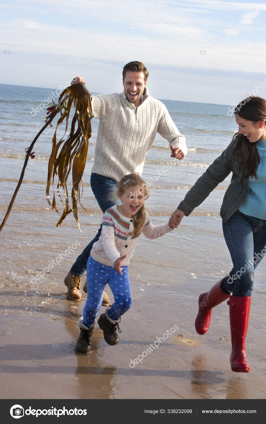Young Father Chasing His Daughter His Partner Beach Some Seaweed ...