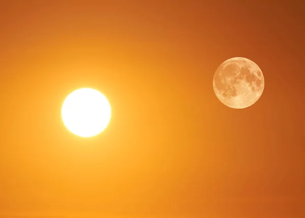 the sun and the moon can be seen in the sky at the same time. - Stock ...