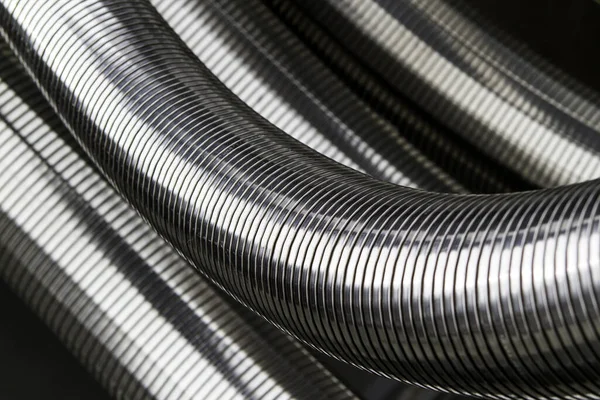 silver-colored metal hoses as grooved,flexible connectors. - Stock ...