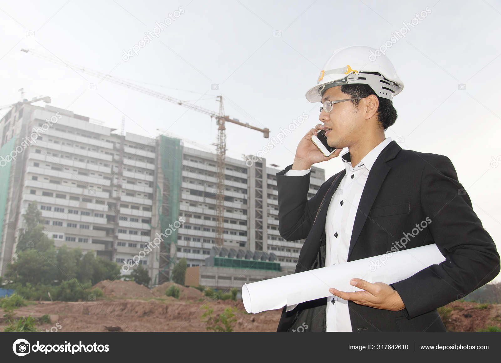 Engineer Holding Blueprints Speaking Phone Construction Site Stock ...