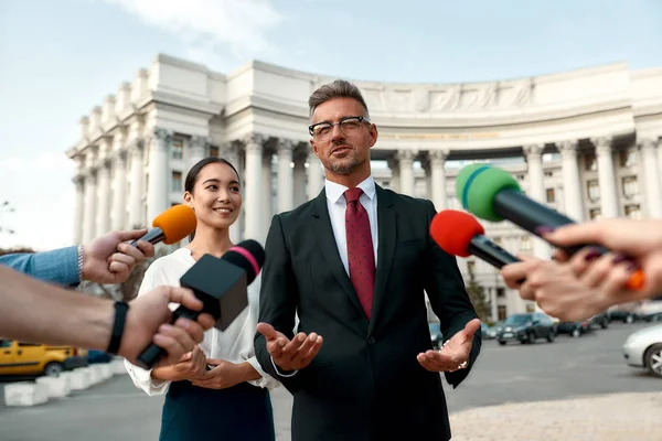 Get the real story. Journalists conducting interview of politician. Journalism industry, live ...