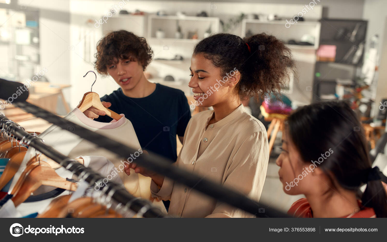 Put customers first. People looking at already made items. Young man ...