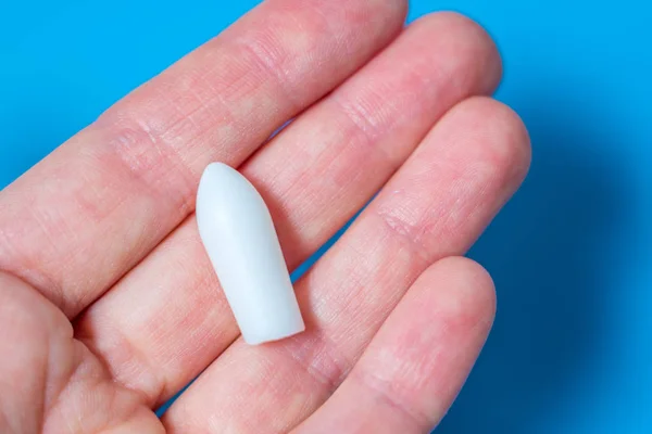 Suppository for anal or vaginal use in the hands of a man. Candles for ...