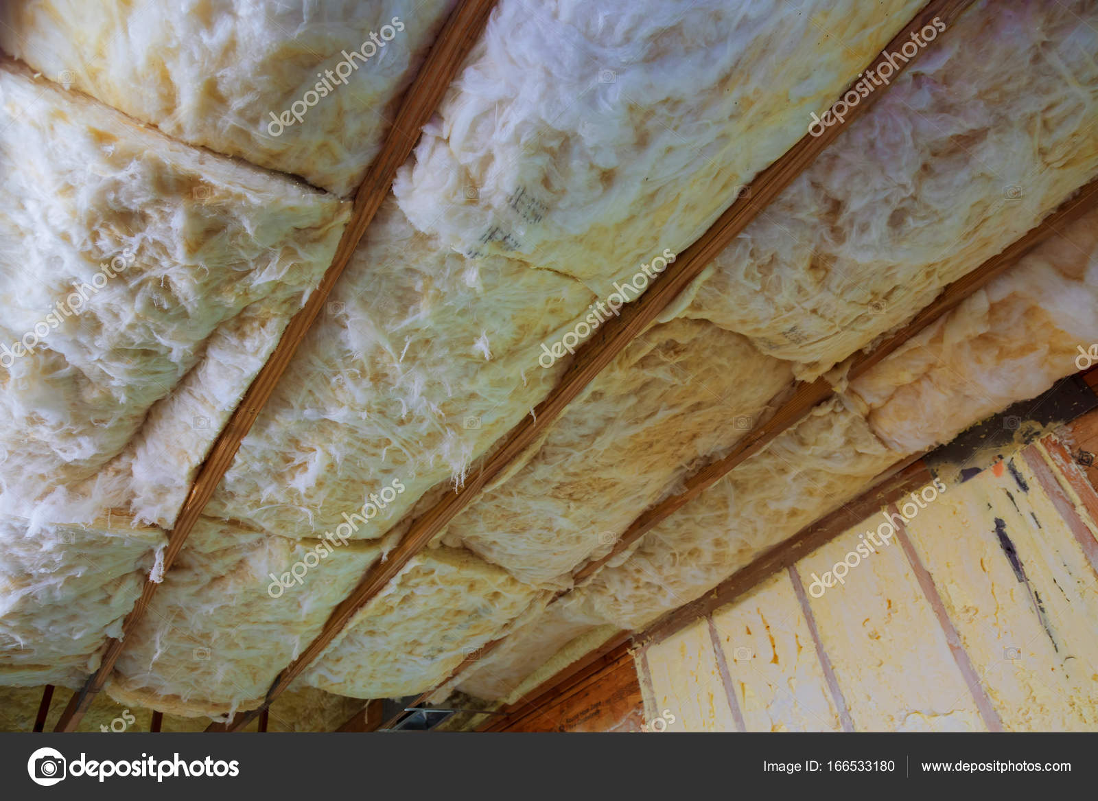 Close-up of strips of pink fiberglass insulation in a wall — Stock ...