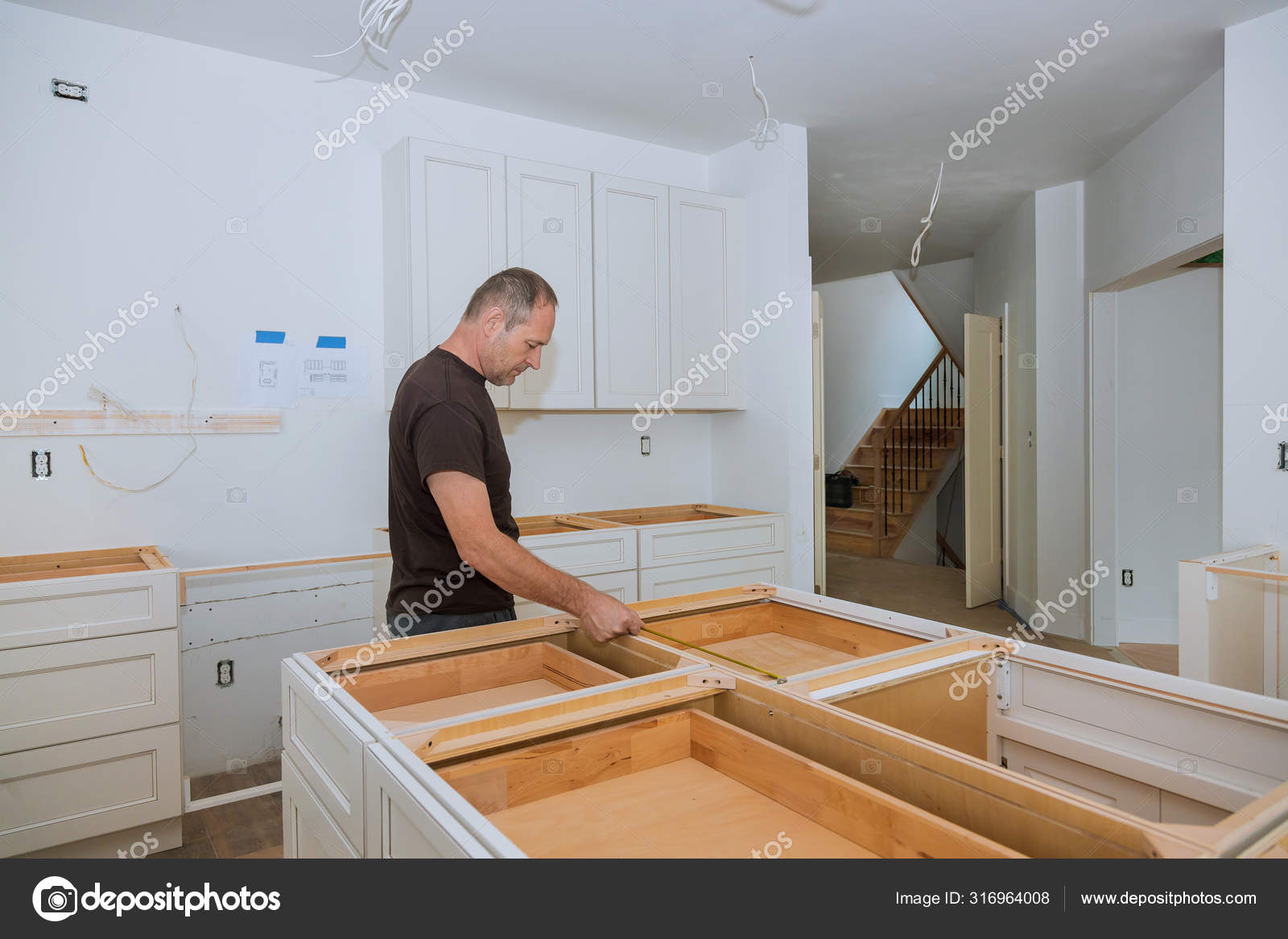 Man using tape measure for measuring on kitchen in for home improvement ...