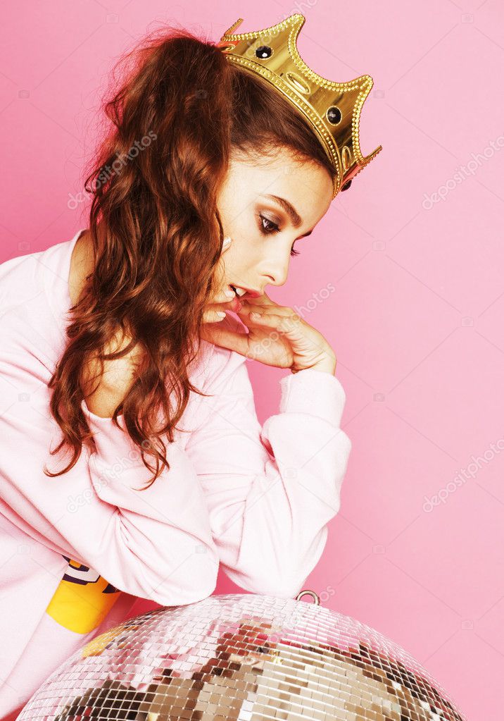Young cute disco girl on pink background with disco ball and cro ...