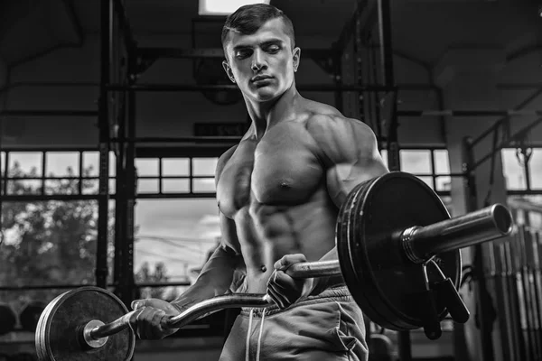 Attractive tall muscular bodybuilder doing heavy deadlifts in mo ...