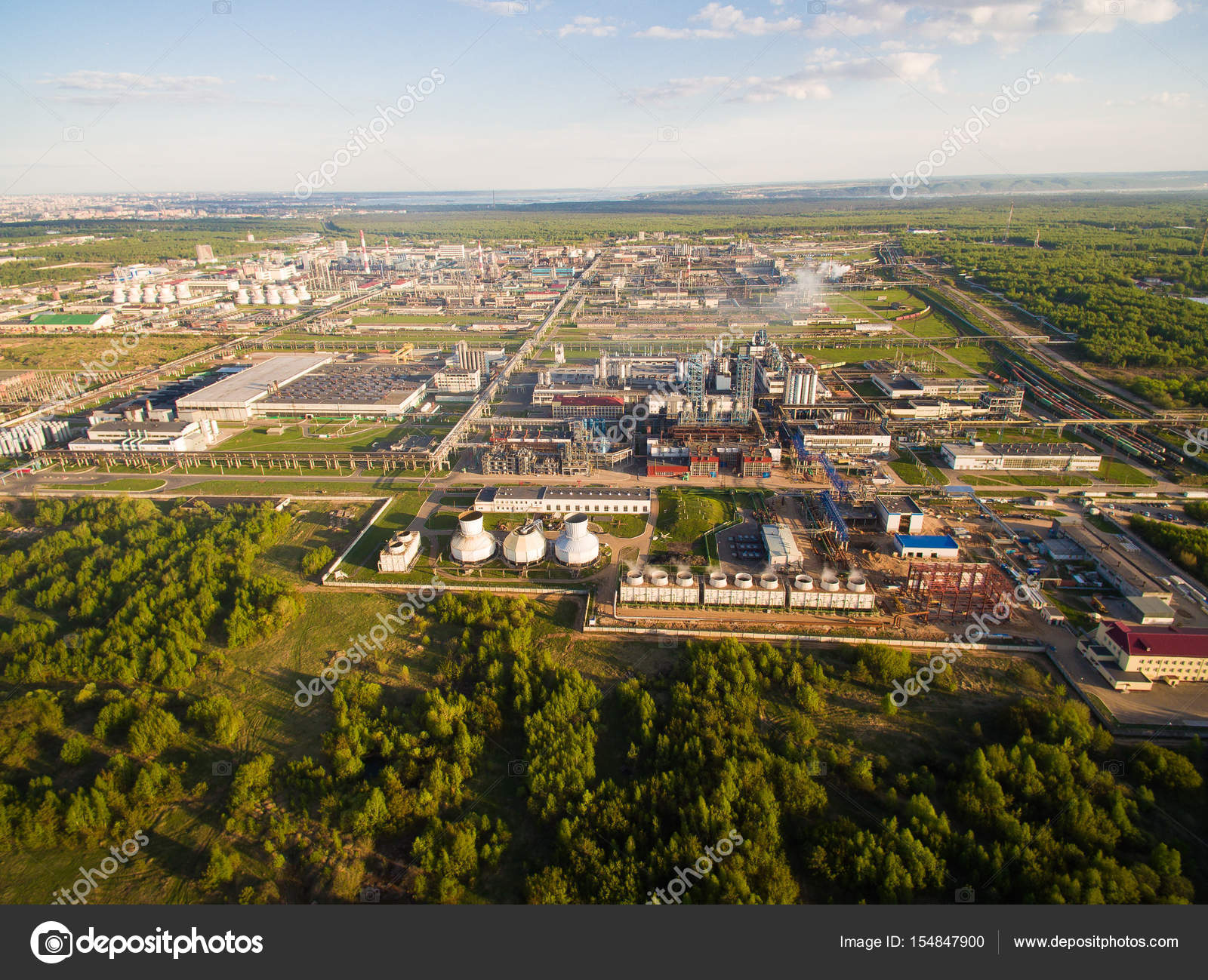 A huge oil refinery with pipes and distillation of the complex on a ...