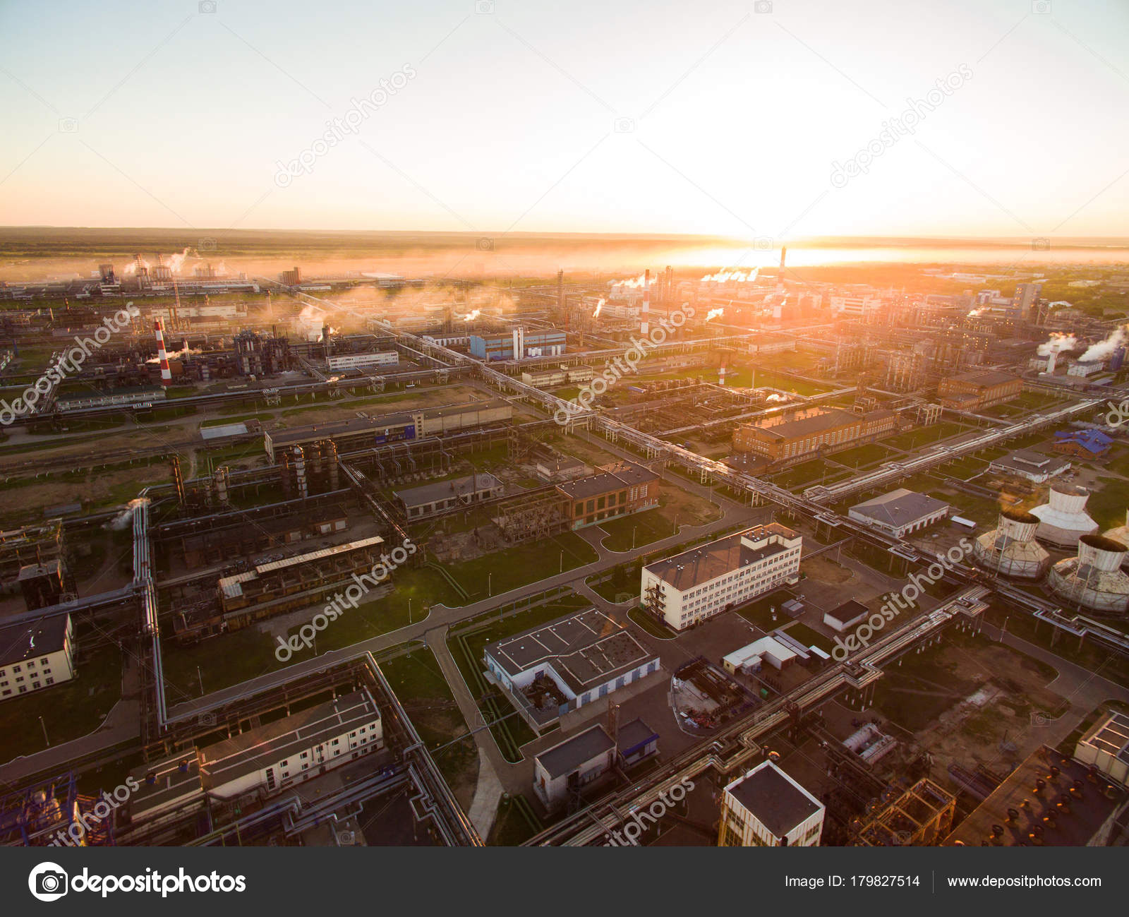 A huge oil refinery with metal structures, pipes and distillation of ...