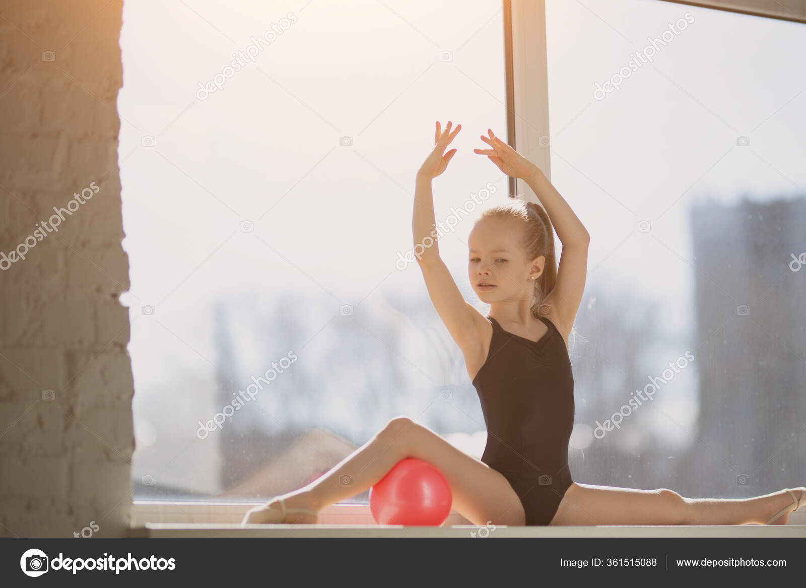 Talented gymnast did the splits and beautifully pulled his hand up. The ...