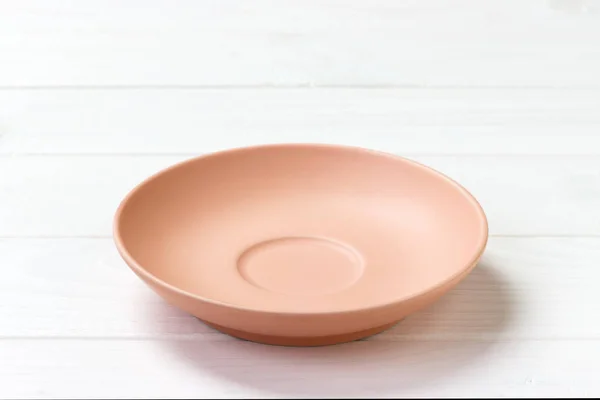 Orange round plate top view on a background of old wood table plank ...