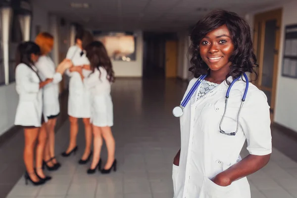 African medical student smiles at the university against the backdrop ...