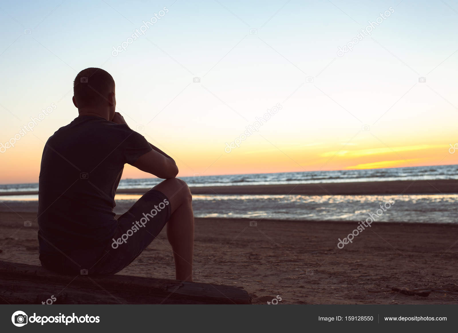 Burdened by unseen worries. Sad lonely man sits on beach — Stock Photo ...