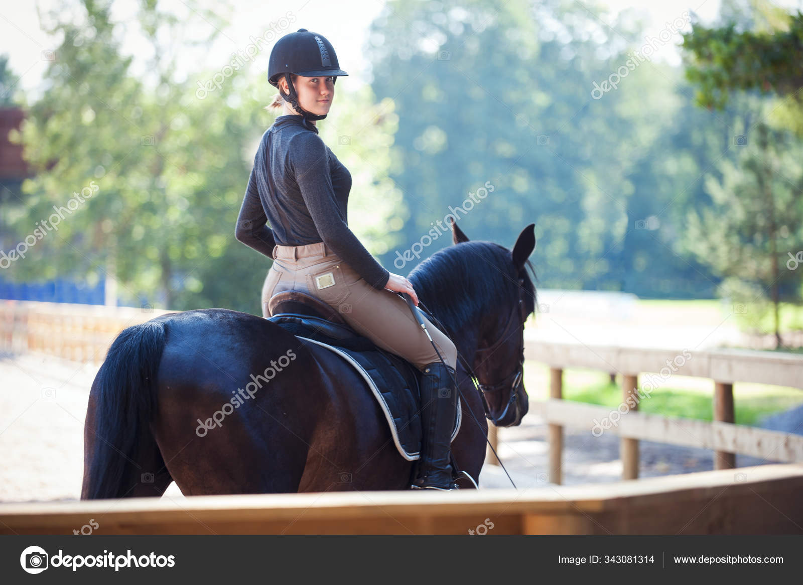 Young pretty girl resting after horse riding training on arena — Stock ...