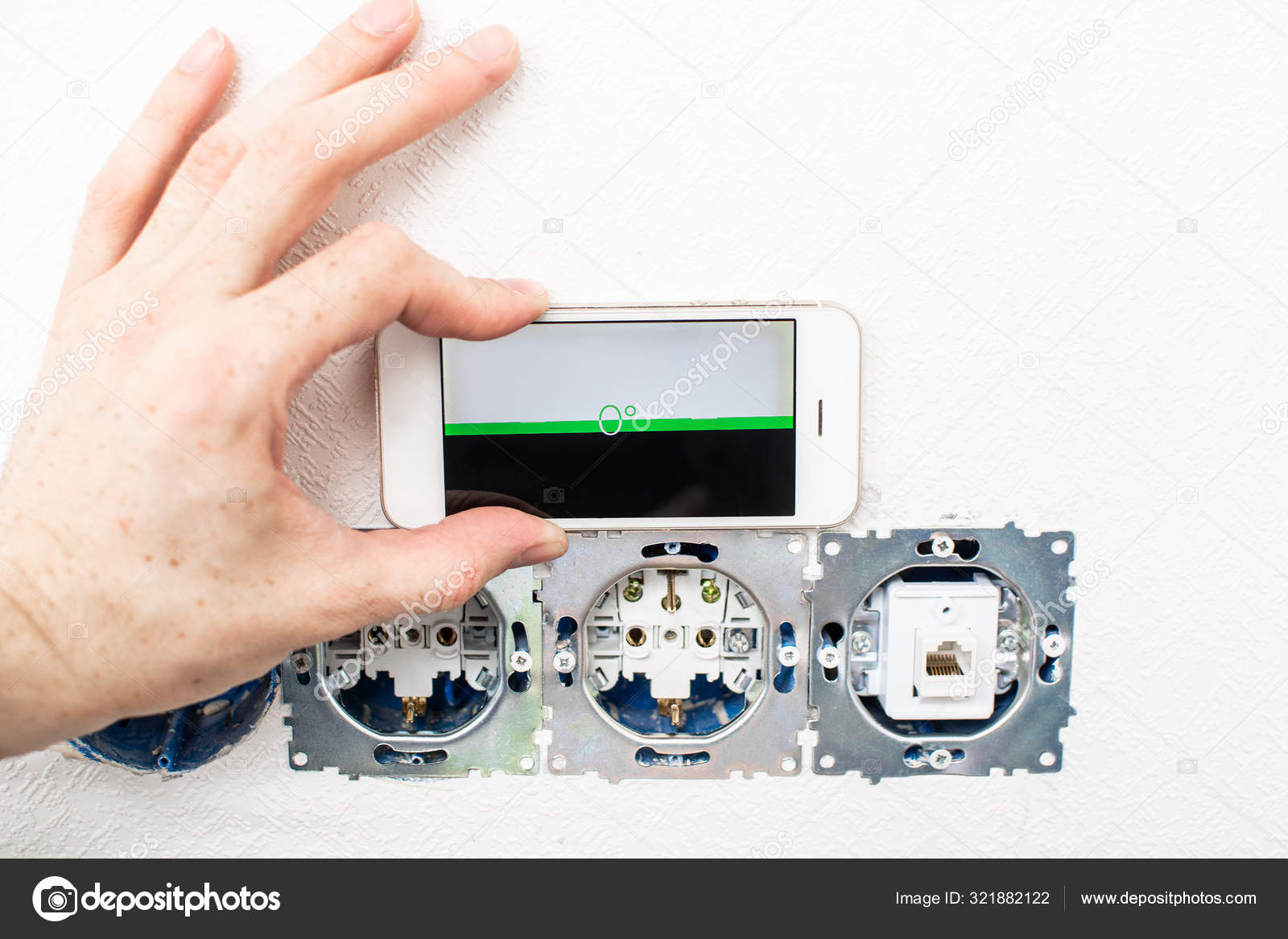 The process of installation electrical sockets level with a smartphone ...