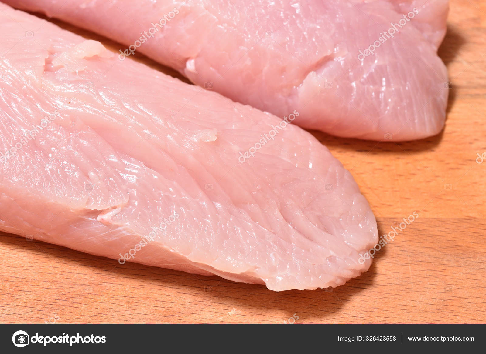 Beautiful and fresh turkey fillet. Fillet of turkey on a wooden cutting ...