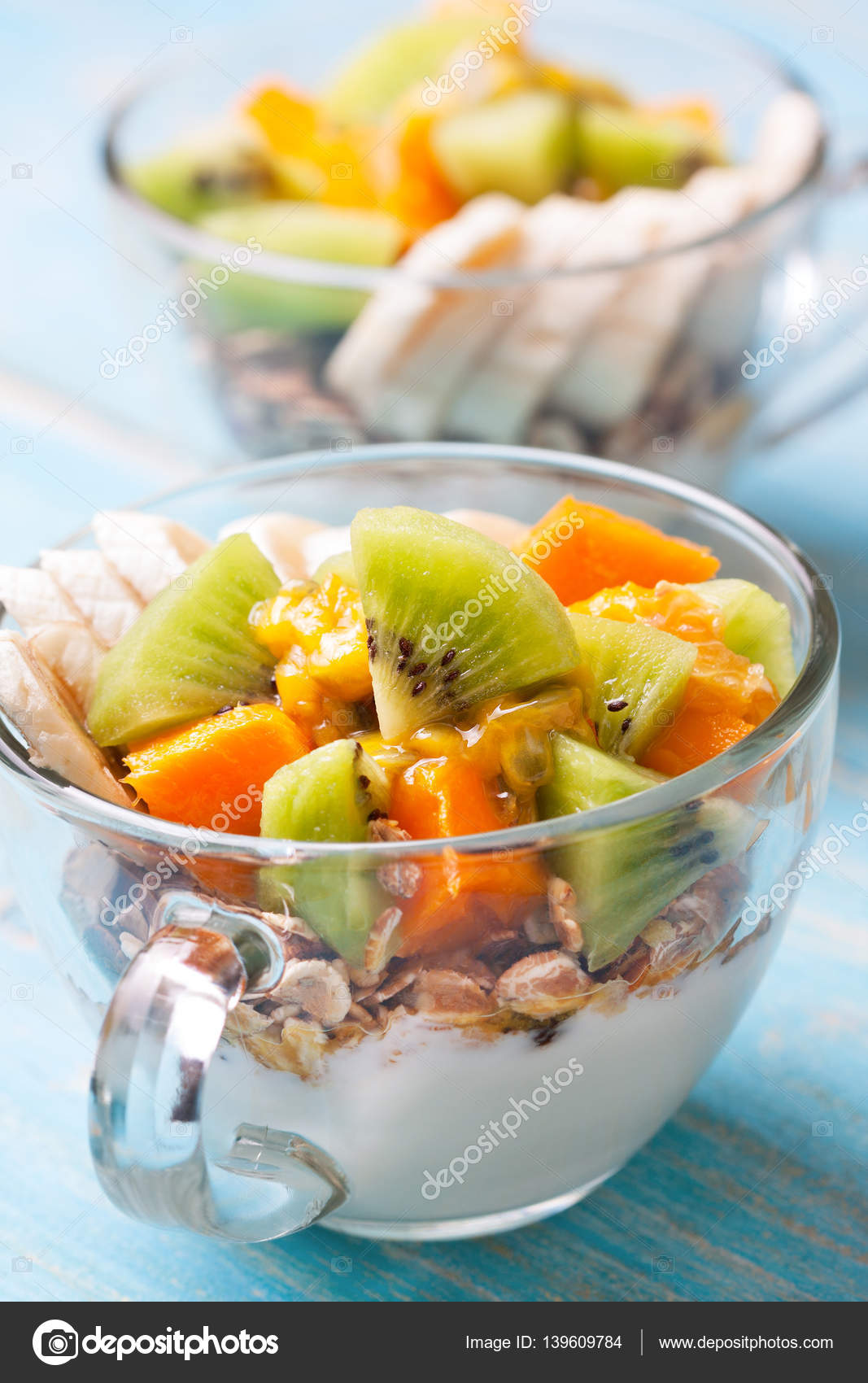 Breakfast with muesli, yoghurt, tropical fruits Stock Photo by ...