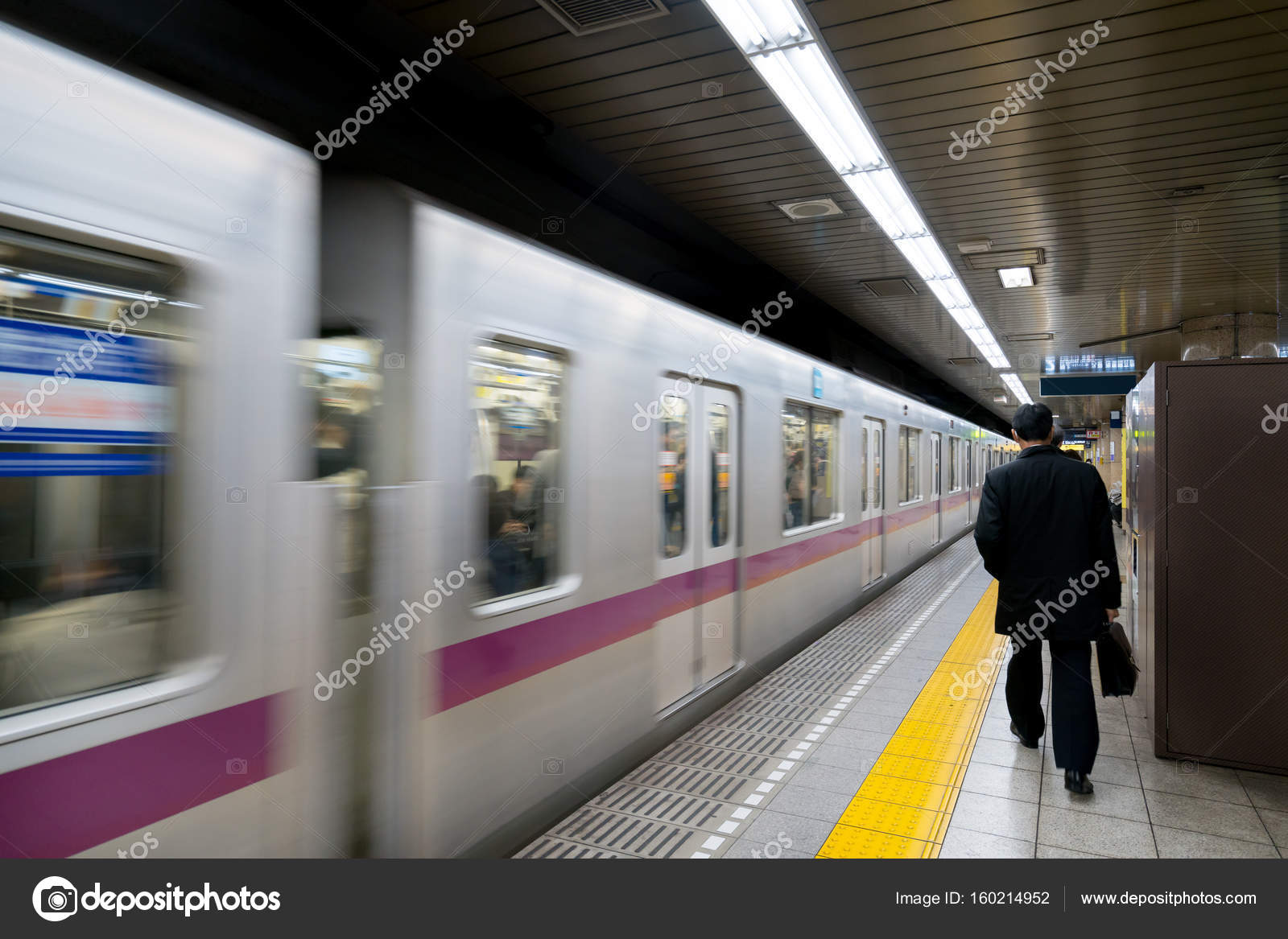 Interior of a Tokyo subway station and platform with subway comm ...