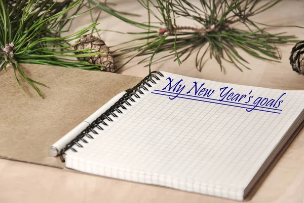 Opened notepad on a wooden desktop. the inscription on the first page ...