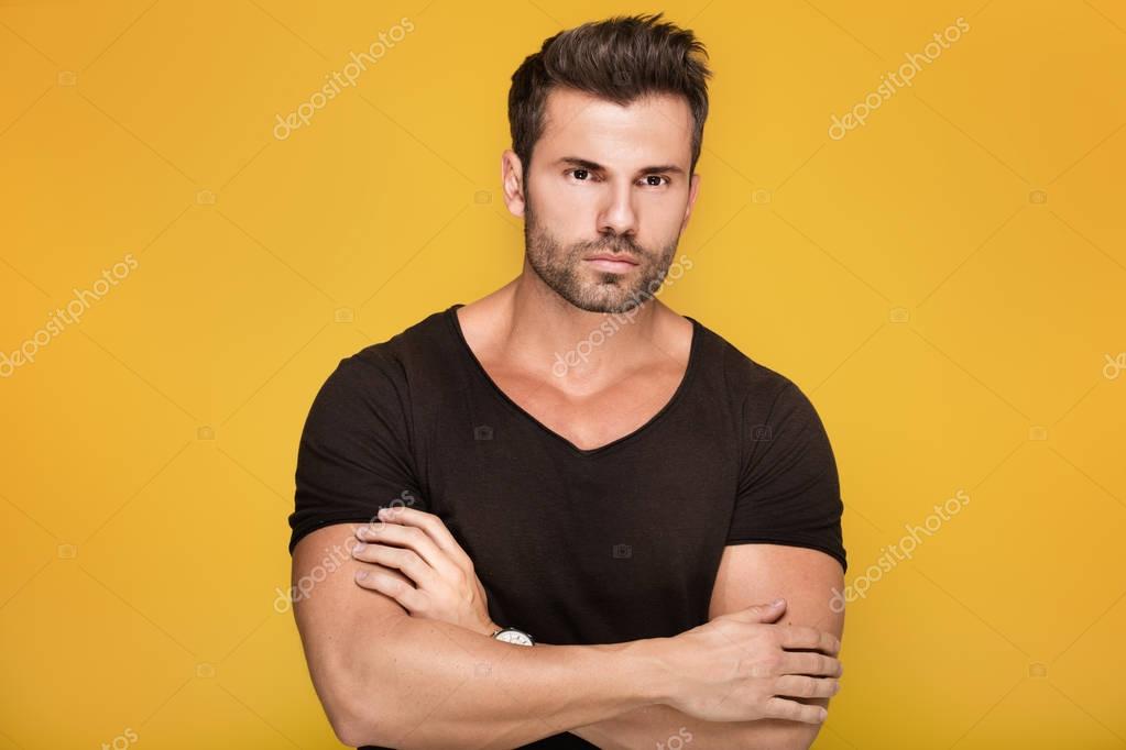Handsome young man posing in studio. Stock Photo by ©NeonShot 129147154