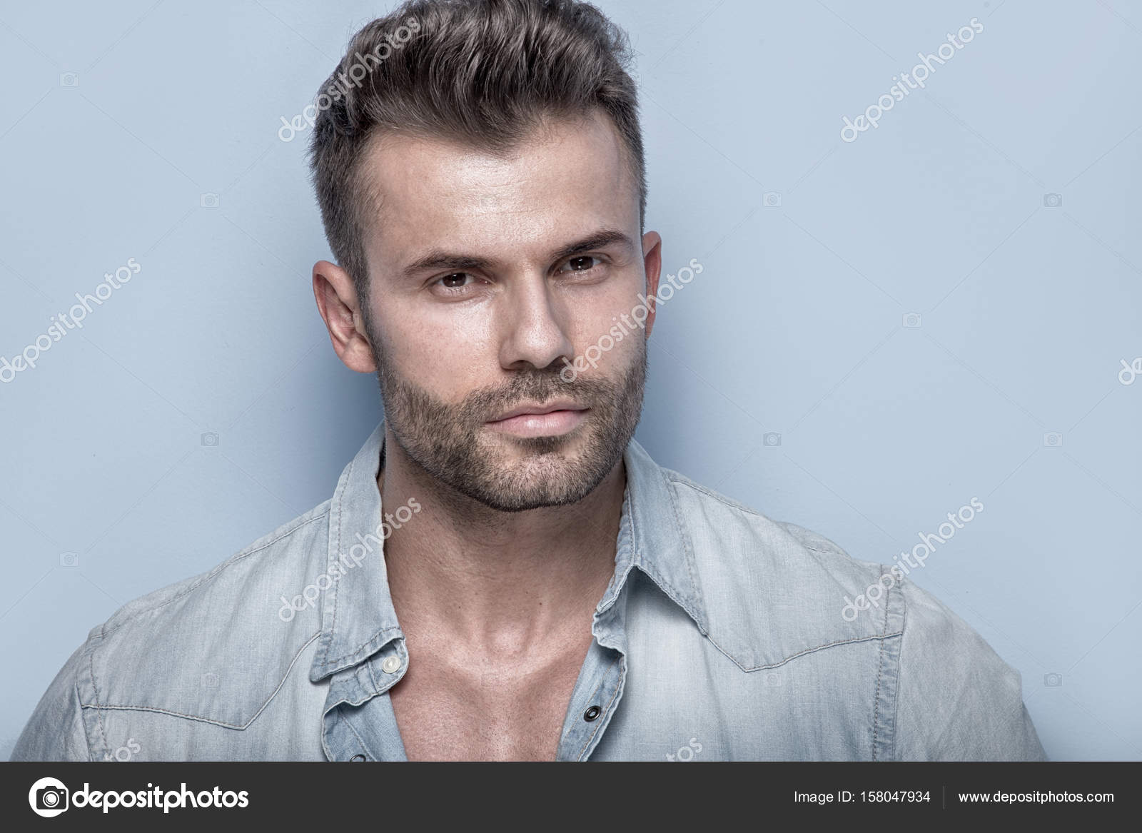 Handsome man posing in studio. — Stock Photo © NeonShot #158047934