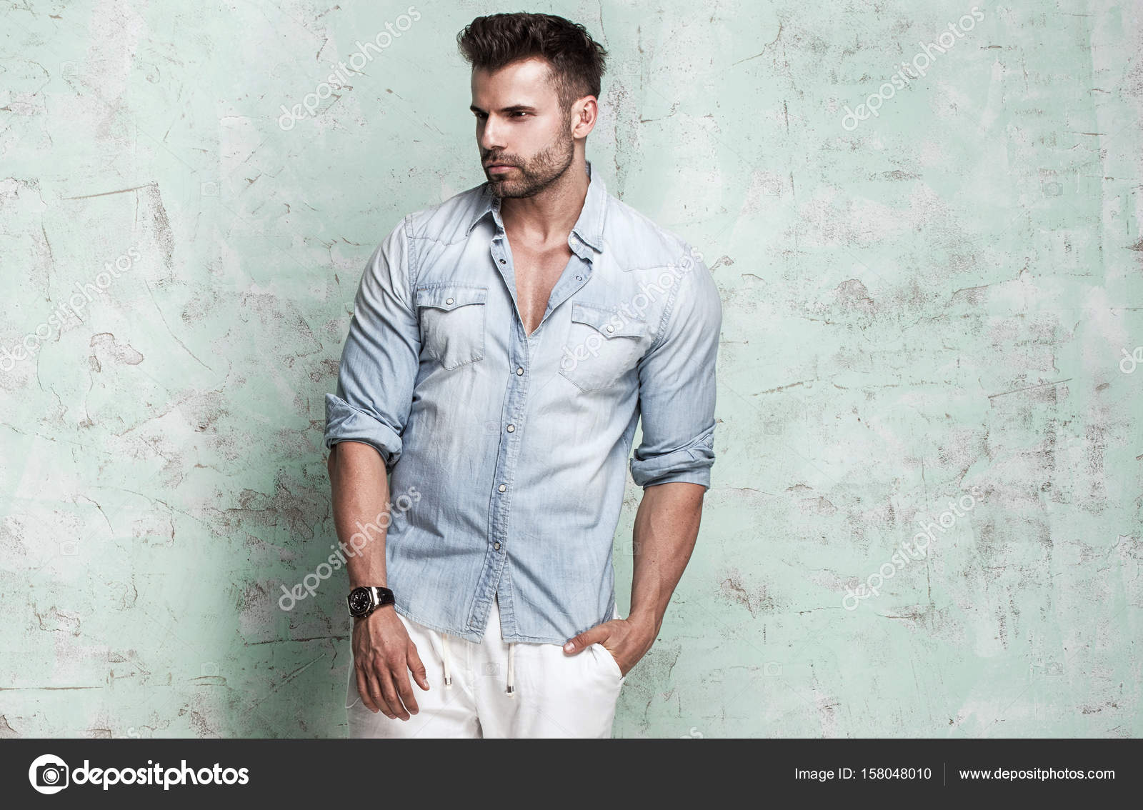 Handsome man posing in studio. Stock Photo by ©NeonShot 158048010