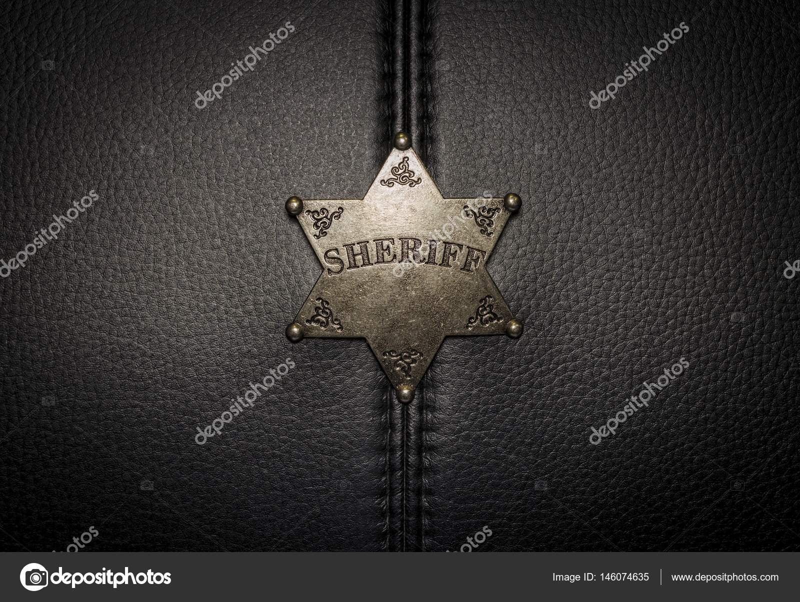 Sheriff badge on black leather texture background. Stock Photo by ...
