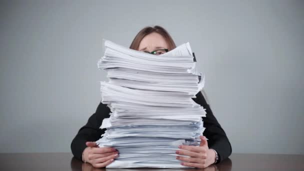 Stack of unfinished paperwork laying at the table in the office room ...