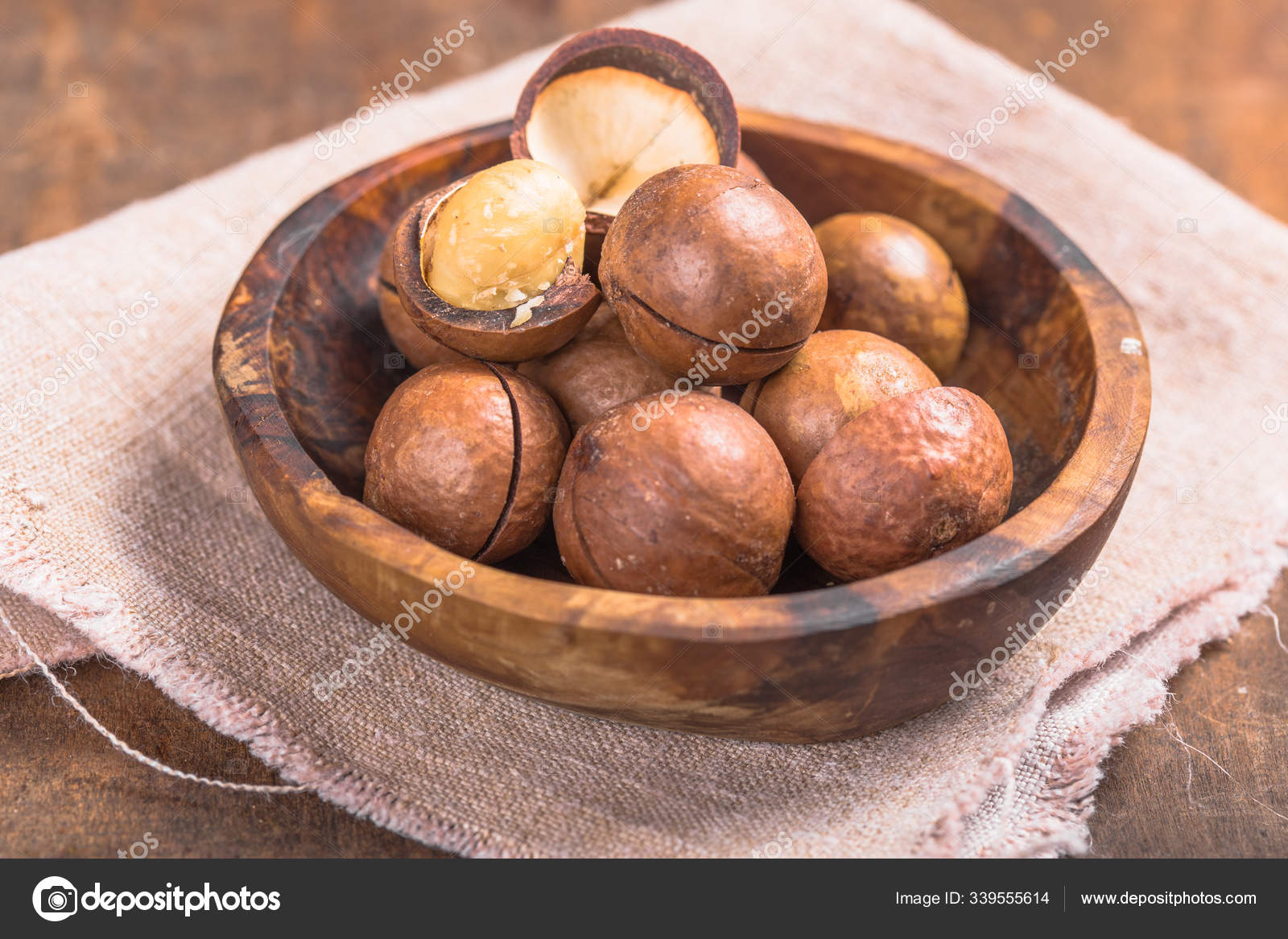 Pile macadamia nuts open kernels and shells in burlap bag on woo Stock ...