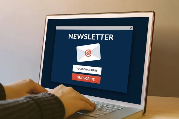 Subscribe newsletter concept on laptop computer screen on wooden table ...
