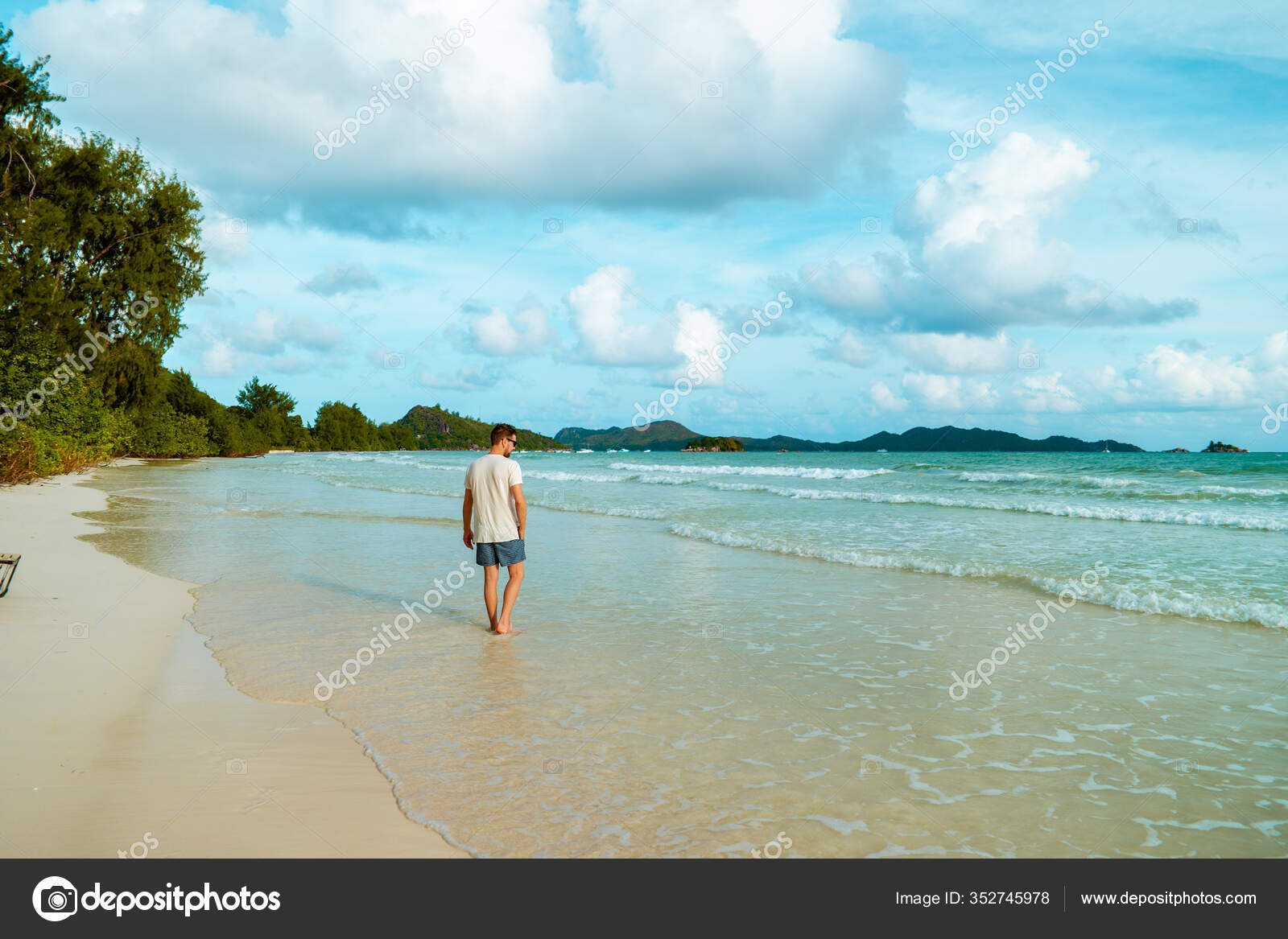 Praslin Seychelles,young men on tropical beach with palm tree, white ...
