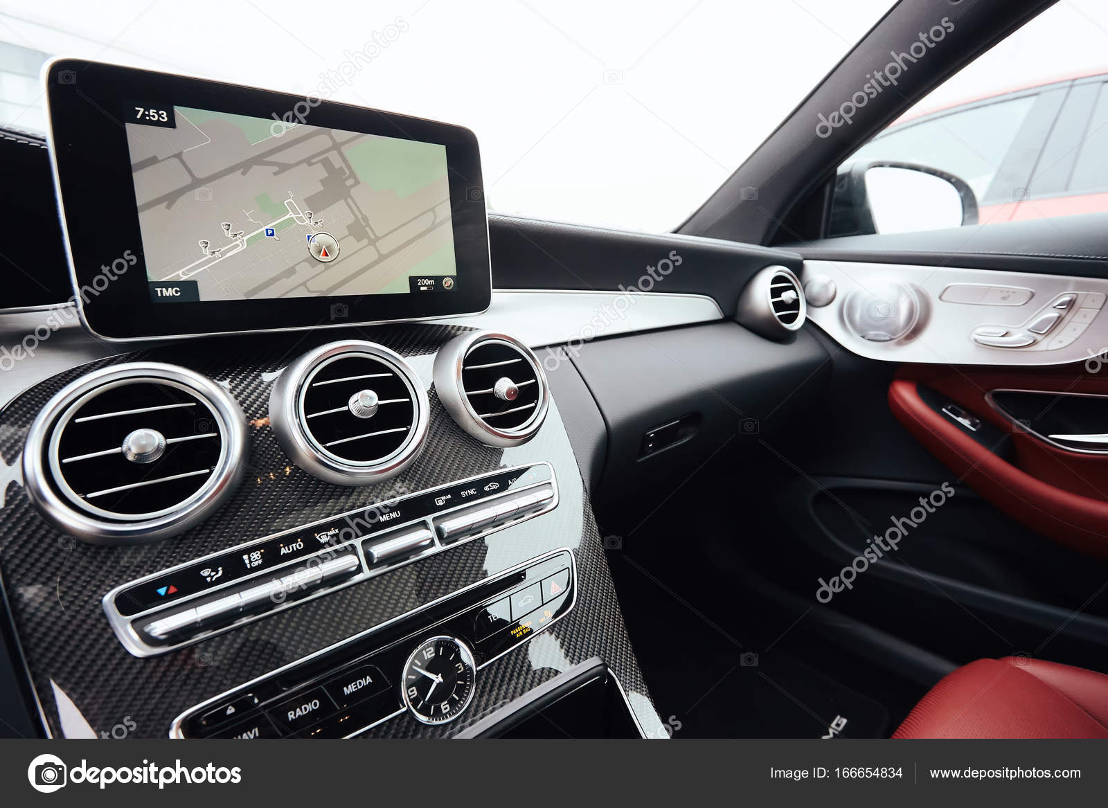 View from inside a car on a part of dashboard with a navigation unit ...