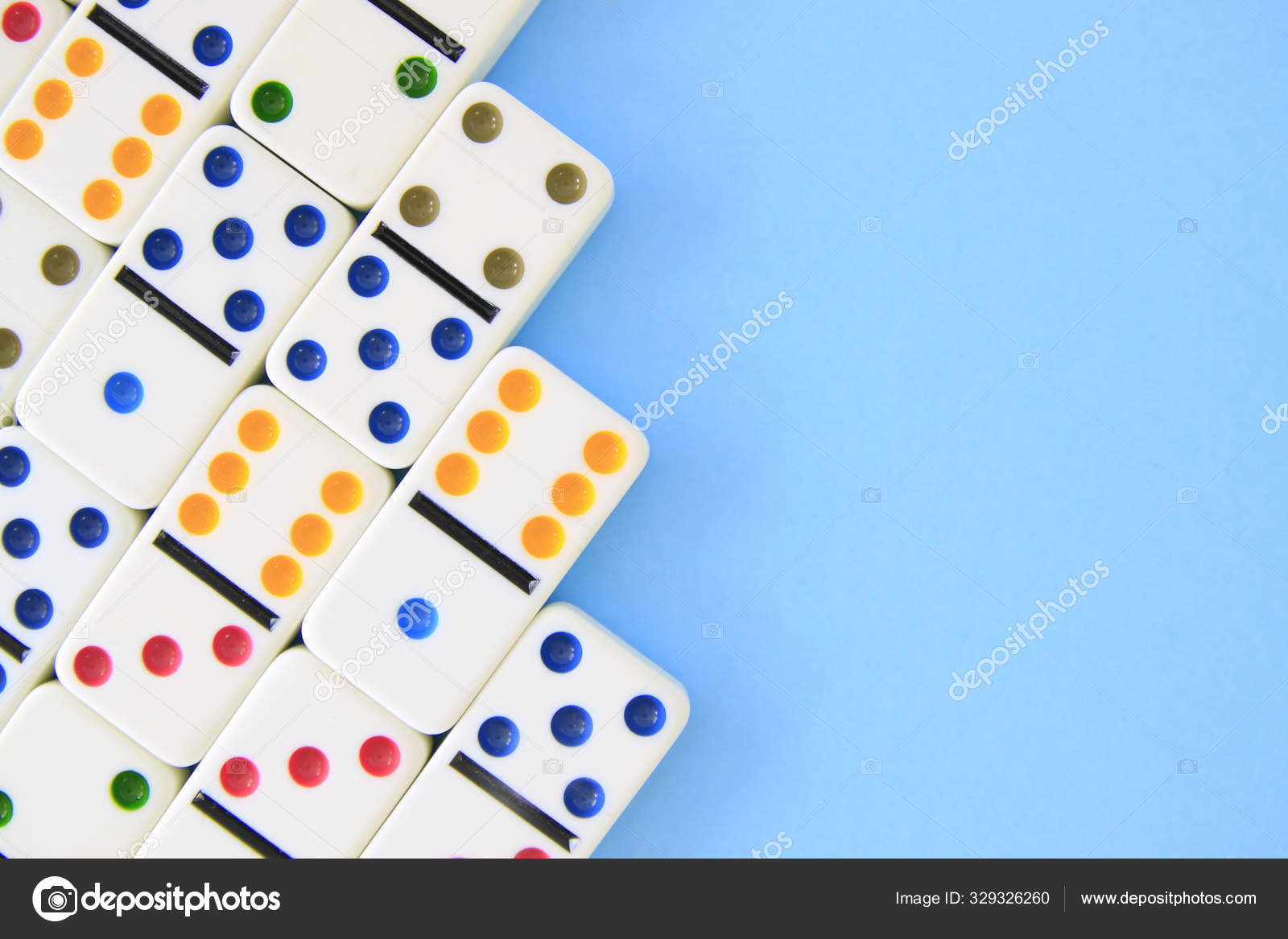 White dominos with brightly colored dots on blue background shot Stock ...