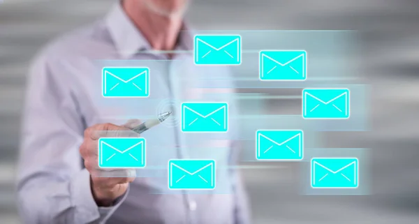 Man touching an email sending concept on a touch screen with a pen ...